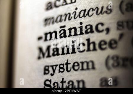 Definition of word maniac on dictionary page, close-up Stock Photo - Alamy