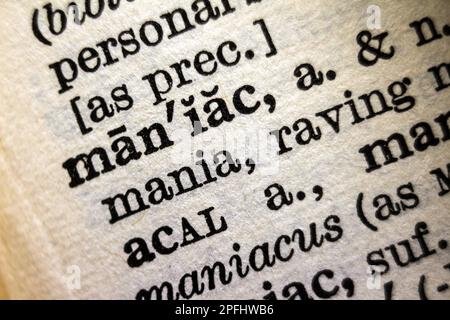 Definition of word maniac on dictionary page, close-up Stock Photo - Alamy