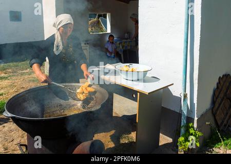 Kazakh Woman preparing the traditional local tandyr bread, Shymkent ...