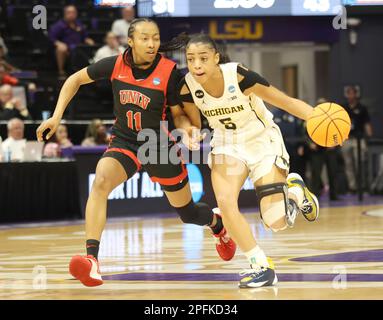 Michigan guard Laila Phelia (5) drives to the basket as Miami forward ...