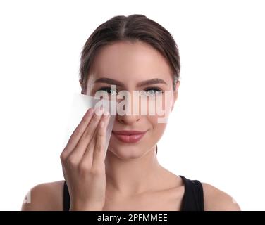 Beautiful woman using mattifying wipe on light blue background Stock ...