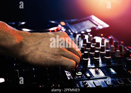 DJ creating music on modern console mixer in night club, closeup Stock ...