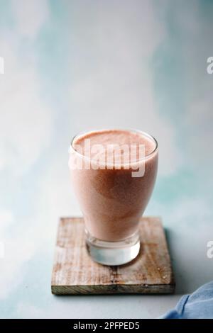 Healthy nutritious chikoo or Sapota milkshake served in a glass ...