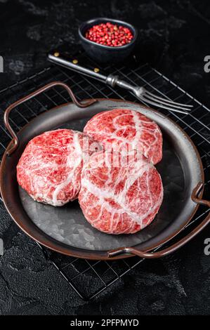 Raw pork cutlet, Crepinette with spices and herbs. Black background ...