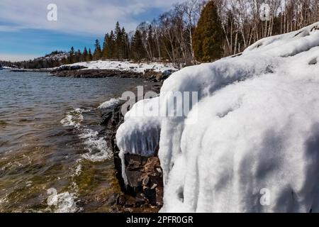 Ice left by water splashed up from waves below Split Rock Lighthouse on ...