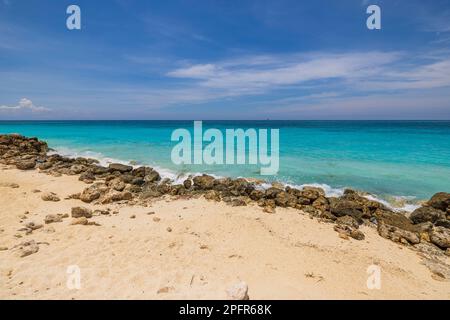 View of big rocks protecting sandy coastline. Turquoise water of ...
