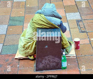 homeless man begging sitting with heart on bag on street glasgow uk ...