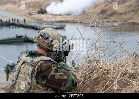 A Republic of Korea Army (ROKA) engineer watches an M-9 Armored Combat ...
