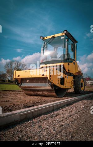 a big bulldozer stands on the sports field Stock Photo - Alamy