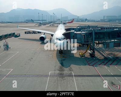 Hong Kong - March 1, 2023: Airplane at boarding gate jet bridge in Hong ...