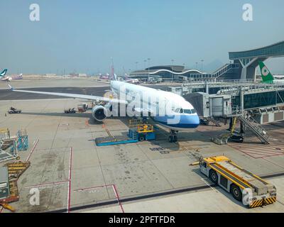 Hong Kong - March 1, 2023: Airplane at boarding gate jet bridge in Hong ...