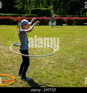 Child playing with hula hoop and training her skills Stock Photo - Alamy