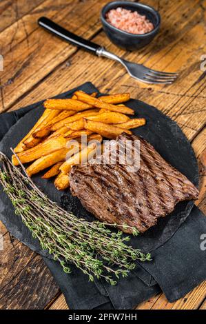 Venison dear steak with sea salt and french fry, game meat. Wooden ...