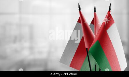 Small flags of the Oman on an abstract blurry background Stock Photo ...