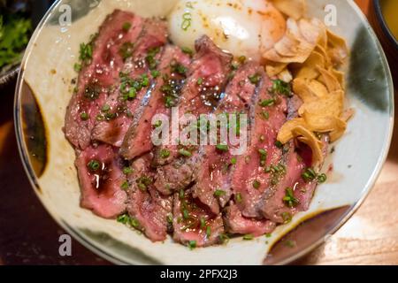 Steak Don, a Japanese dish consisting of a bowl of rice topped with ...