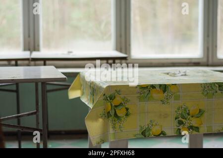 Old, dilapidated tables and coffee tables in an abandoned building ...