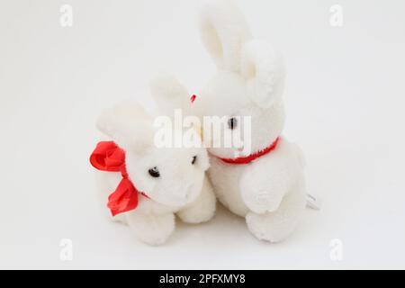 Two White Soft Rabbits with Red Bows Stock Photo - Alamy