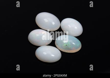 Natural precious stone noble opal on a black background Stock Photo - Alamy