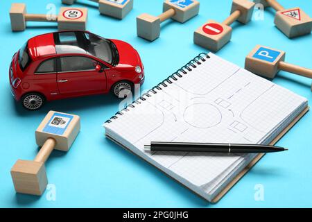 Different road signs, notebook with sketch of roundabout and toy car on ...