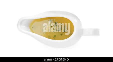 Ceramic sauce boat with lemon salad dressing on white background Stock ...