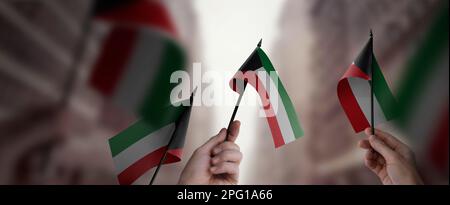 Hands Holding Flag of the Nation Kuwait Stock Photo - Alamy