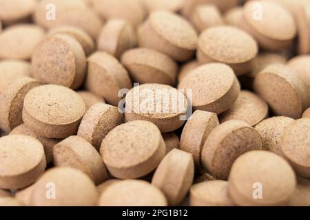 Brewer's yeast pills. Dietary supplement tablets in rustic wooden bowl ...