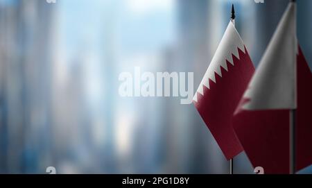 Small flags of the Qatar on an abstract blurry background Stock Photo ...