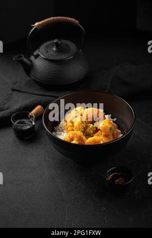 A bowl of delicious spicy asian shrimp noodle soup with mushroom, red ...