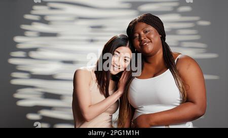 Group of cheerful women promoting body positivity in studio, laughing ...