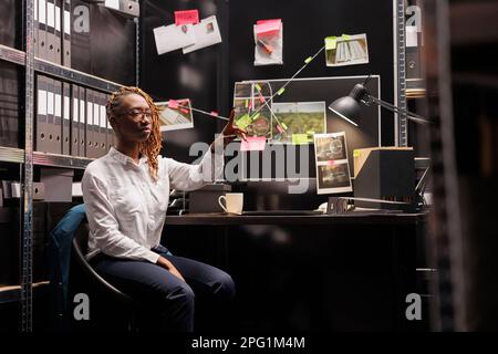 Law enforcement investigator using ar technology to analyze crime scene ...