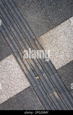 Textured walkway for blind people. Black tactile paving for the ...