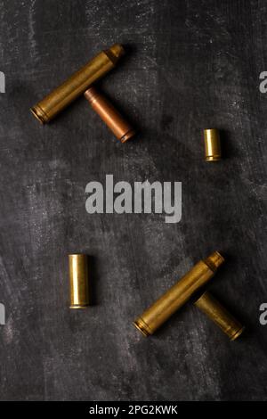Empty bullet cartridges lying on the black background Stock Photo - Alamy