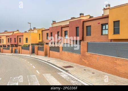 Modern row houses in Terra earth colors in Spain Stock Photo - Alamy
