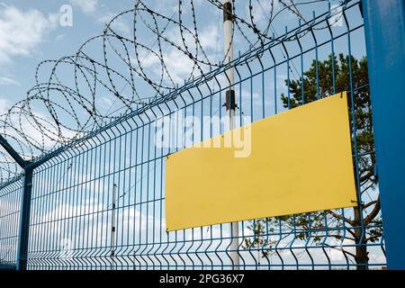 Fencing - yellow sign with blue sky background Stock Photo - Alamy