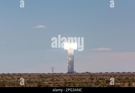 The Khi Solar One solar power tower is visible through a guyed cross ...