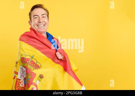 Smiling mature man wrapping with a spanish flag Stock Photo - Alamy