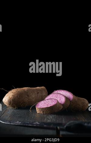 purple yam on table top, dioscorea alata, aka ube, violet yam, water or ...