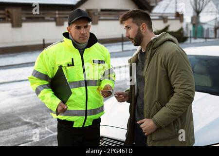Man giving bribe to police officer out of car window outdoors Stock ...