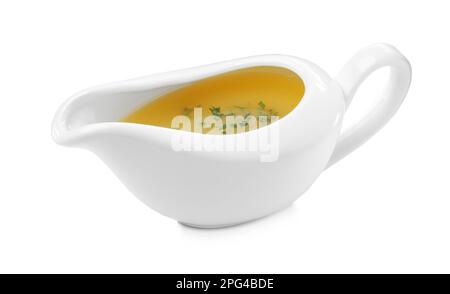 Ceramic sauce boat with lemon salad dressing and ingredients on white ...