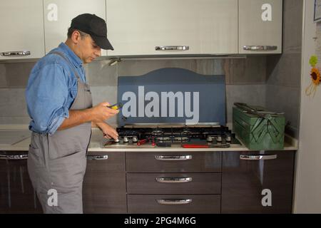 Image of a handyman technician who with a detector carries out checks ...