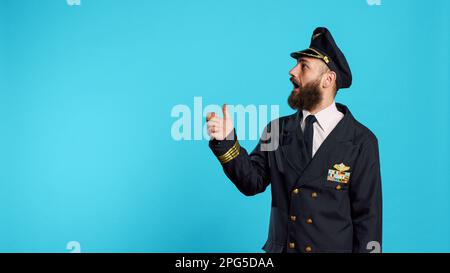 Aircrew captain pointing to left or right sides in studio, indicating ...