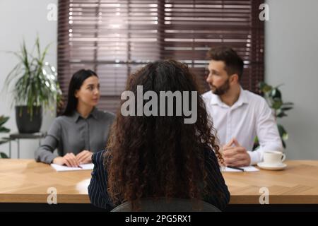 Coworkers conducting job interview with African American man in office ...