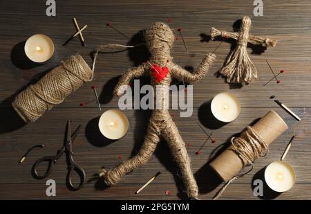 Flat lay composition with voodoo doll on dark wooden table Stock Photo ...