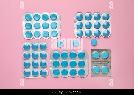 Blue cough drops on pink background, flat lay Stock Photo - Alamy