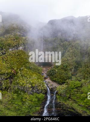 Aerial view, Lagoa do Vento with Upper Risco waterfall, forest and fog ...