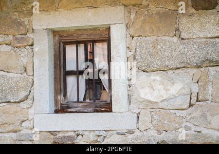 Aged wooden window with glazing and partially weathered in rustic homes ...