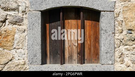 Aged wooden window with glazing and partially weathered in rustic homes ...