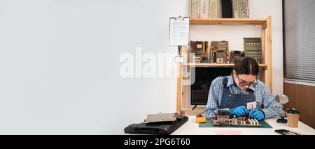 Tech fixes motherboard of laptop in service center Stock Photo - Alamy
