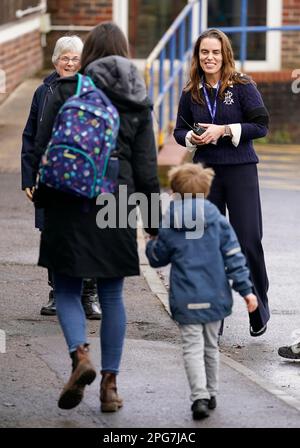 Headteacher Flora Cooper, wearing a black armband, welcomes children to ...