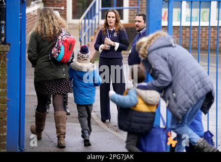 Headteacher Flora Cooper, wearing a black armband, stands next to a ...